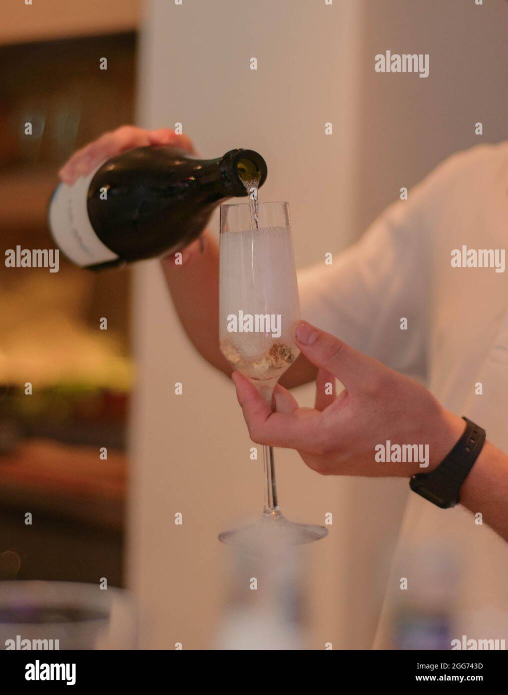 A restaurant waiter serving champagne Stock Photo - Alamy