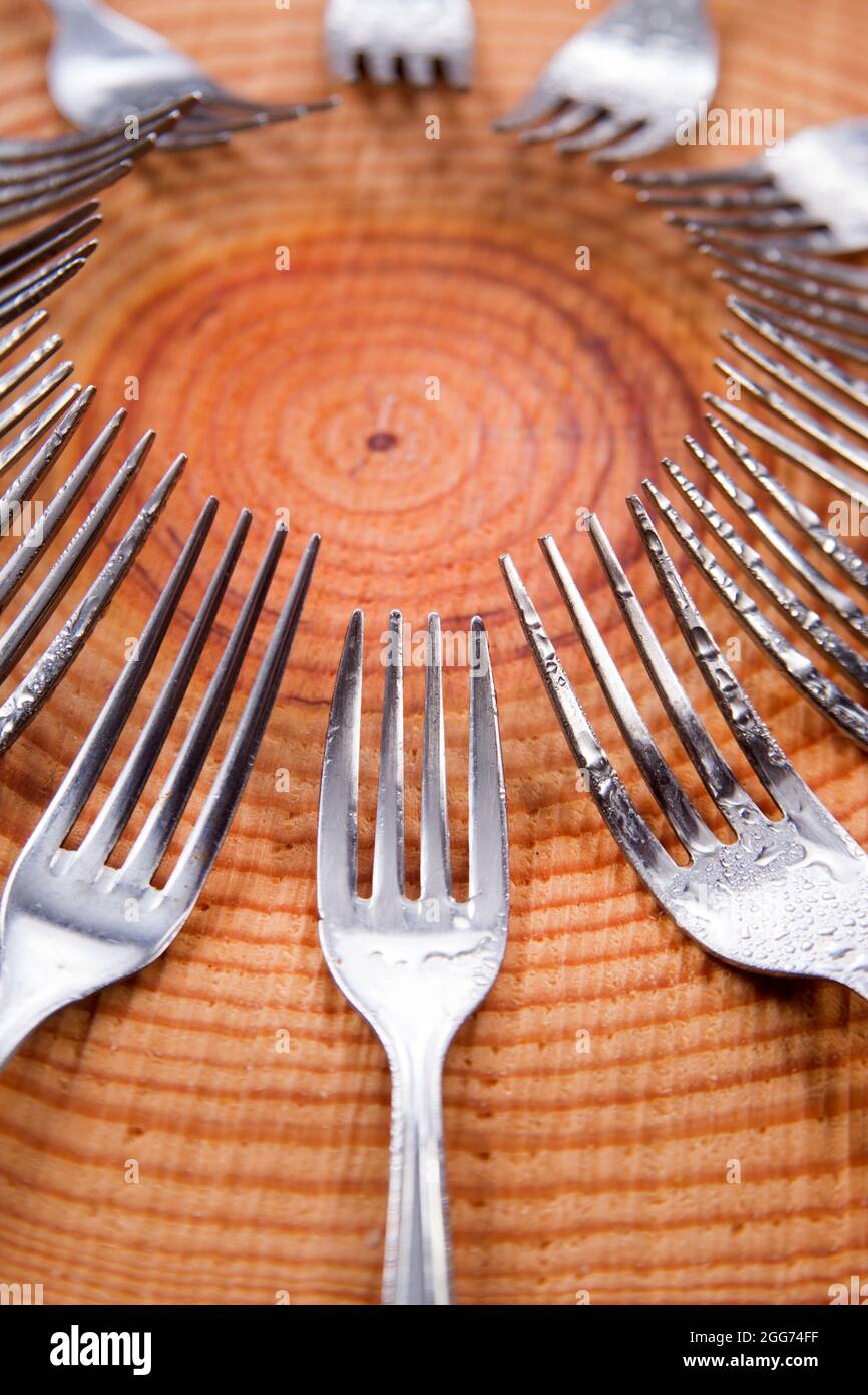 Series of different forks in a circle of pine board Stock Photo - Alamy