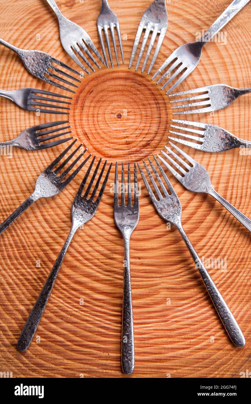 Series of different forks in a circle of pine board Stock Photo - Alamy