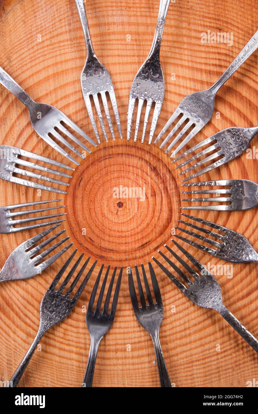 Series of different forks in a circle of pine board Stock Photo - Alamy