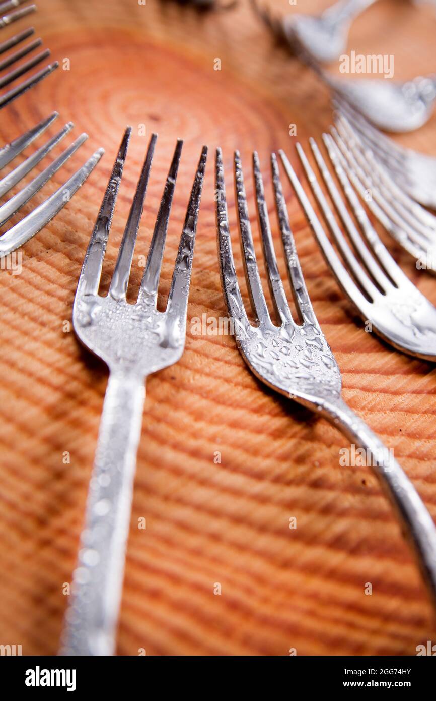 Series of different forks in a circle of pine board Stock Photo - Alamy