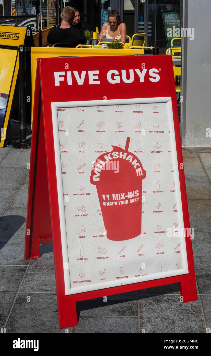 Milkshake sign outside of a Five Guys burger restaurant in Liverpool ...
