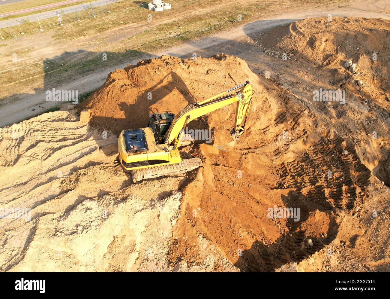 Excavator dig trench in ground at construction site. Foundation pit for ...