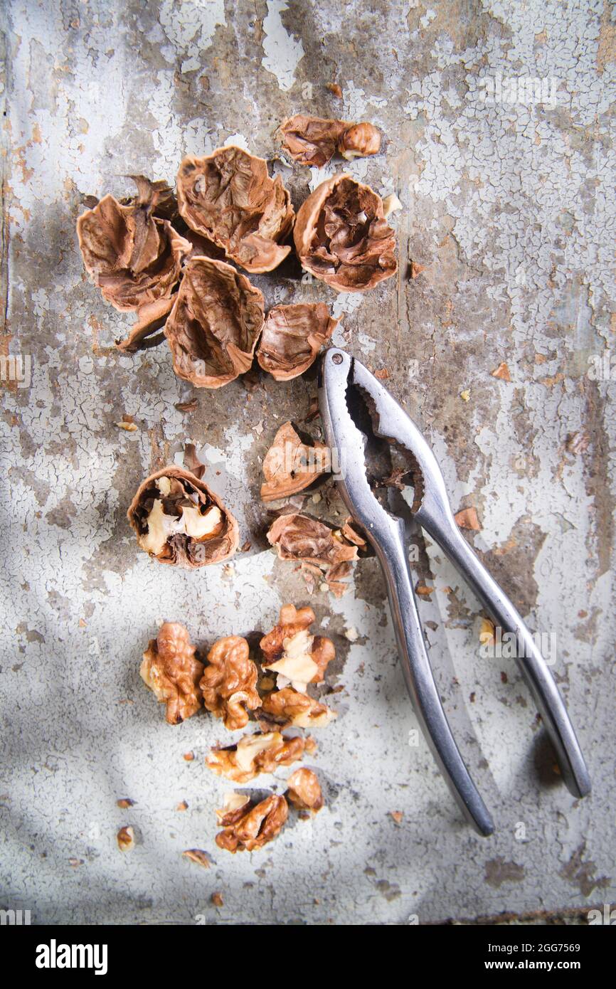 Nuts from organic farming and nutcracker on old table Stock Photo - Alamy
