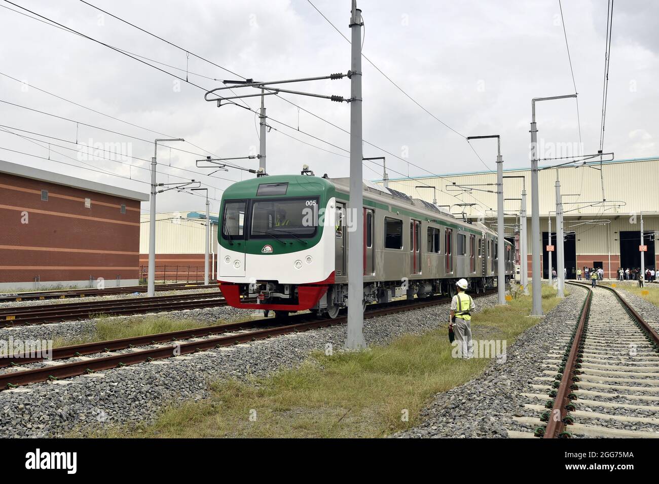A pilot in the Metro station begin drives the electric metro rail train ...