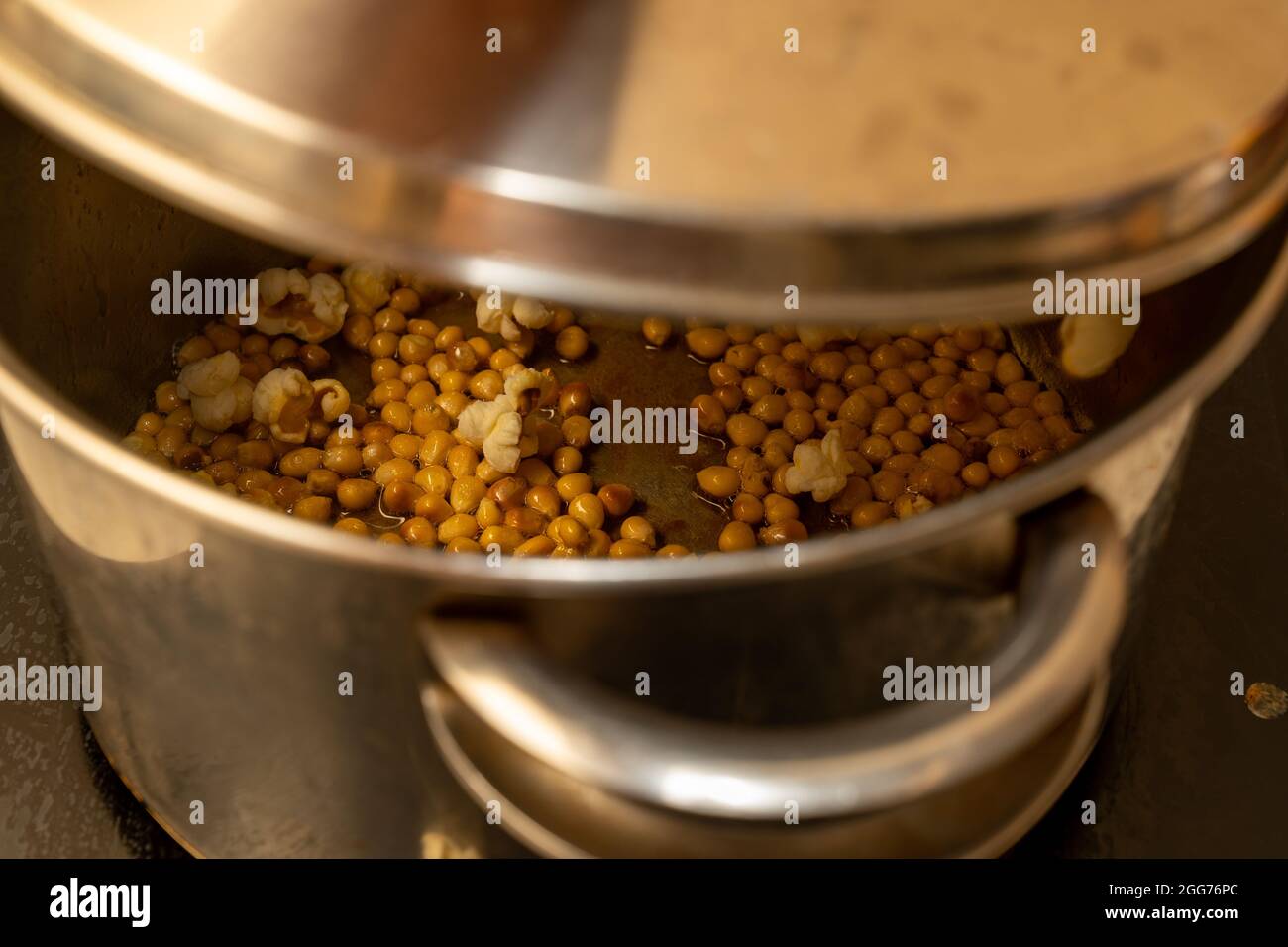 The kitchen pot is filled with corn kernels and a spices mass of cakes ...