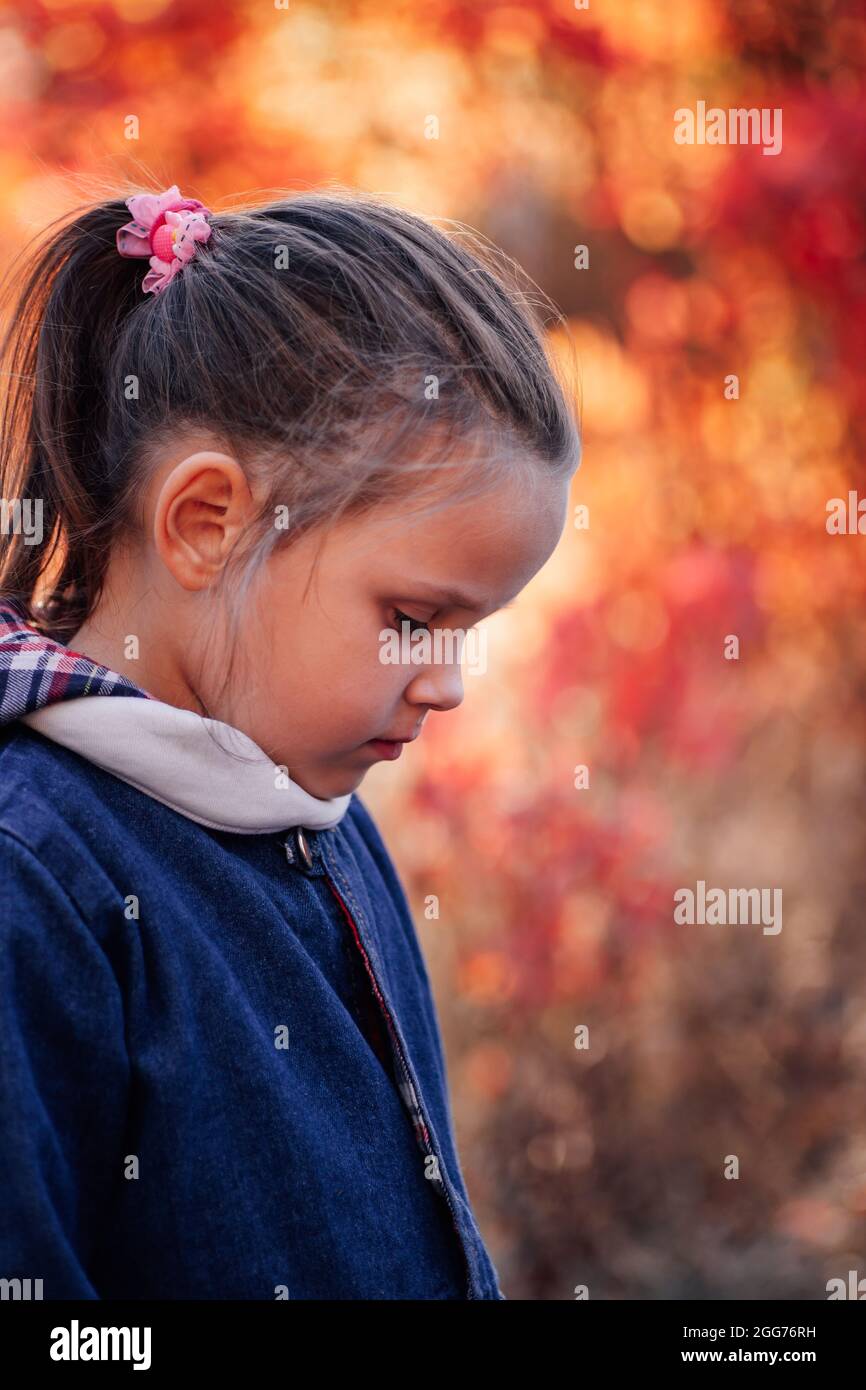 side view girl portrait. beautiful little girl in blue jeans jacket ...