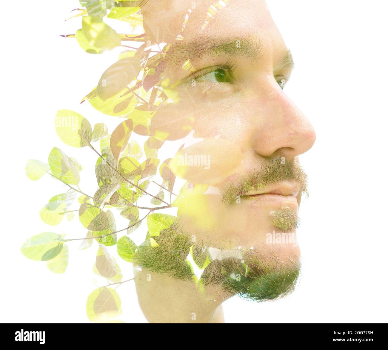 Creative portrait of a young man who admires nature and looks into the ...