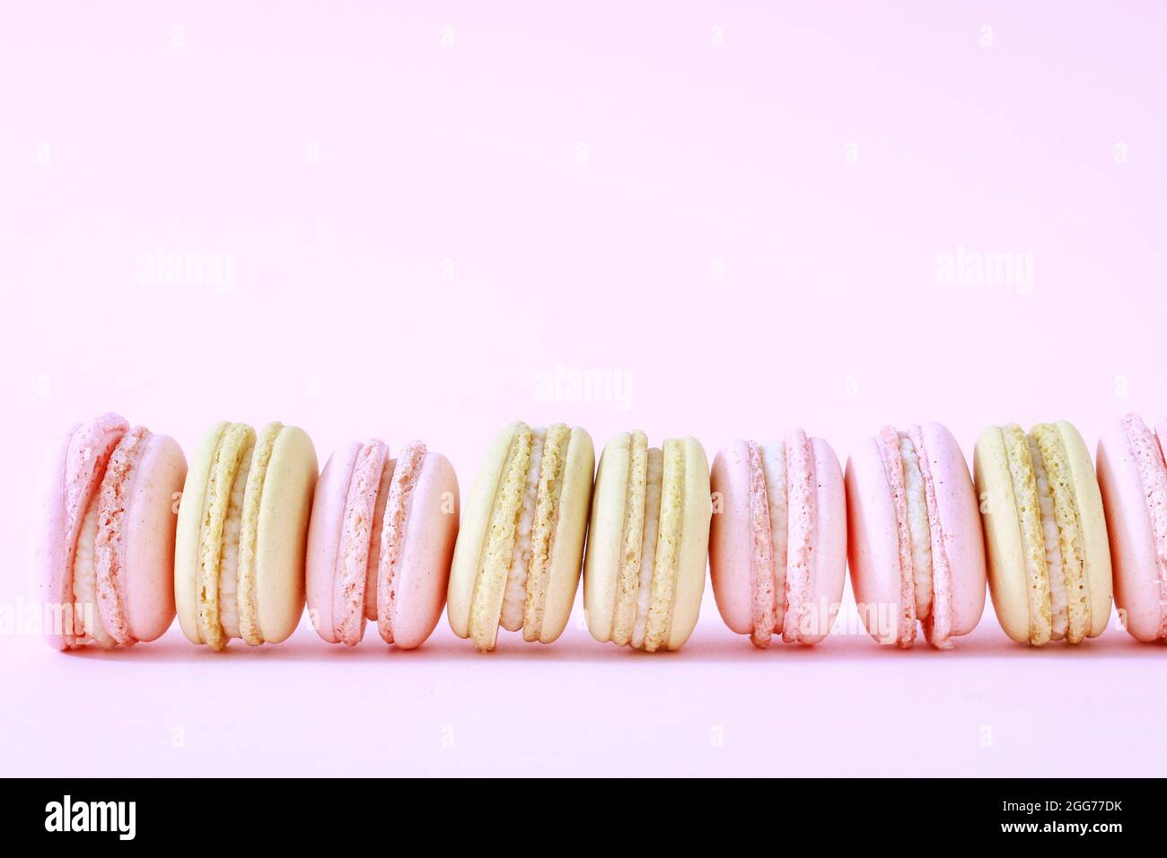 French macaroons on pink background, copy space Stock Photo - Alamy