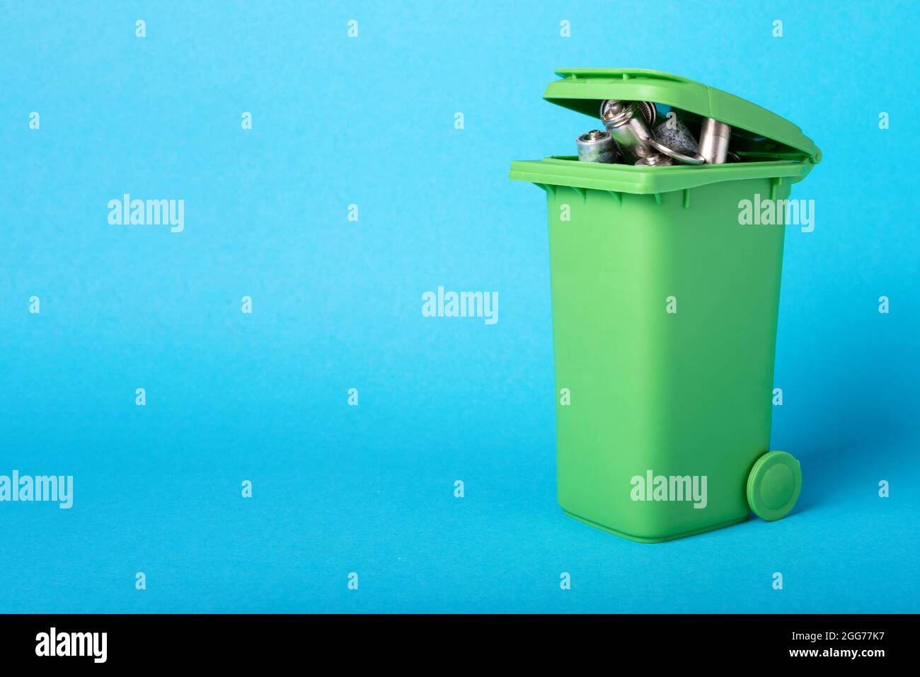 Waste batteries in a plastic container. Waste recycling. Environmental ...