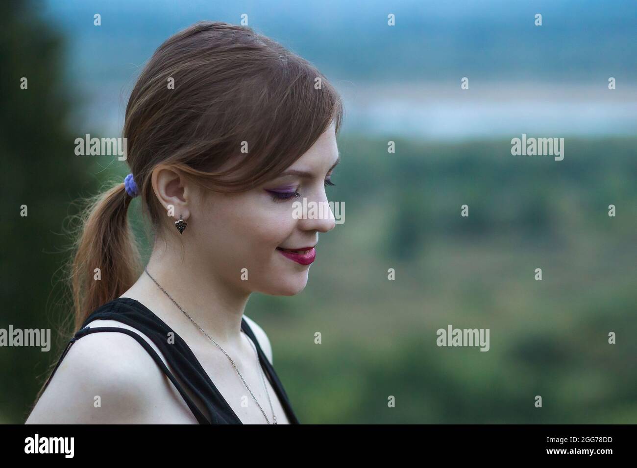 Cinematic portrait of a young woman in nature side view close-up Stock ...