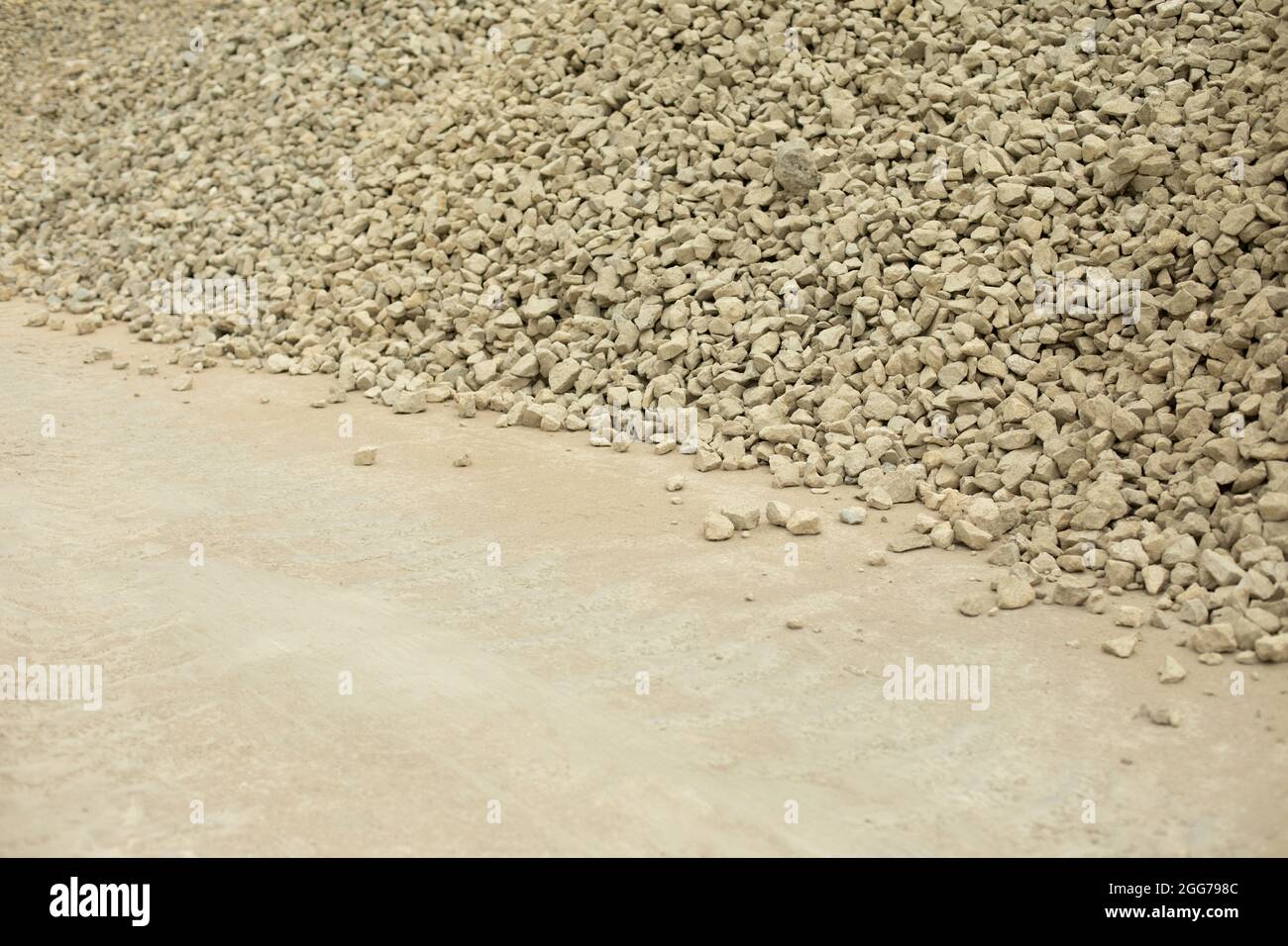 The building stone is poured on the construction site. Small stone for ...