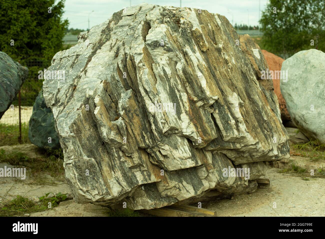 A large green stone for the landscape design of the park. Rock prepared ...
