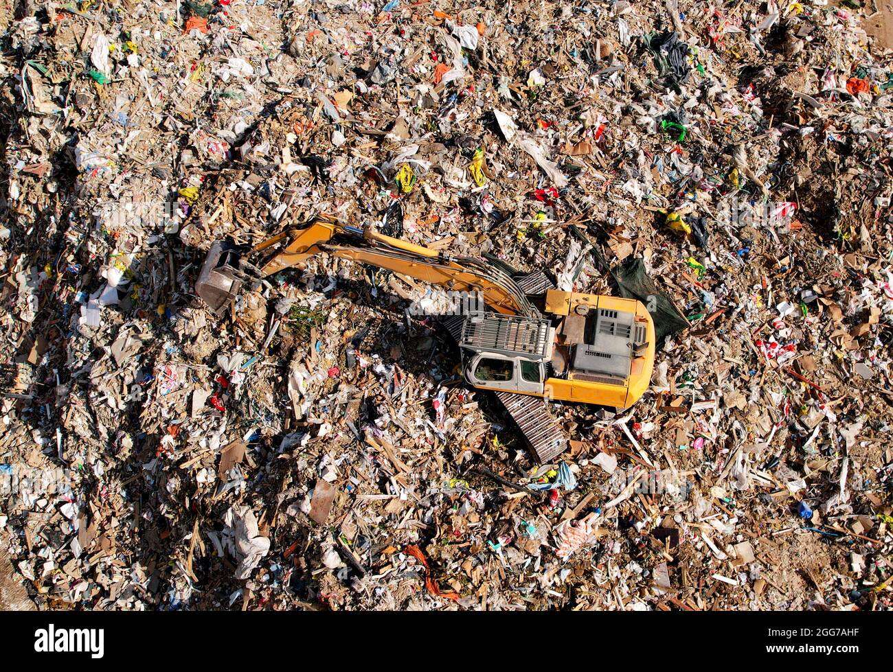 Garbage dump with construction waste. Excavator during recycling of ...