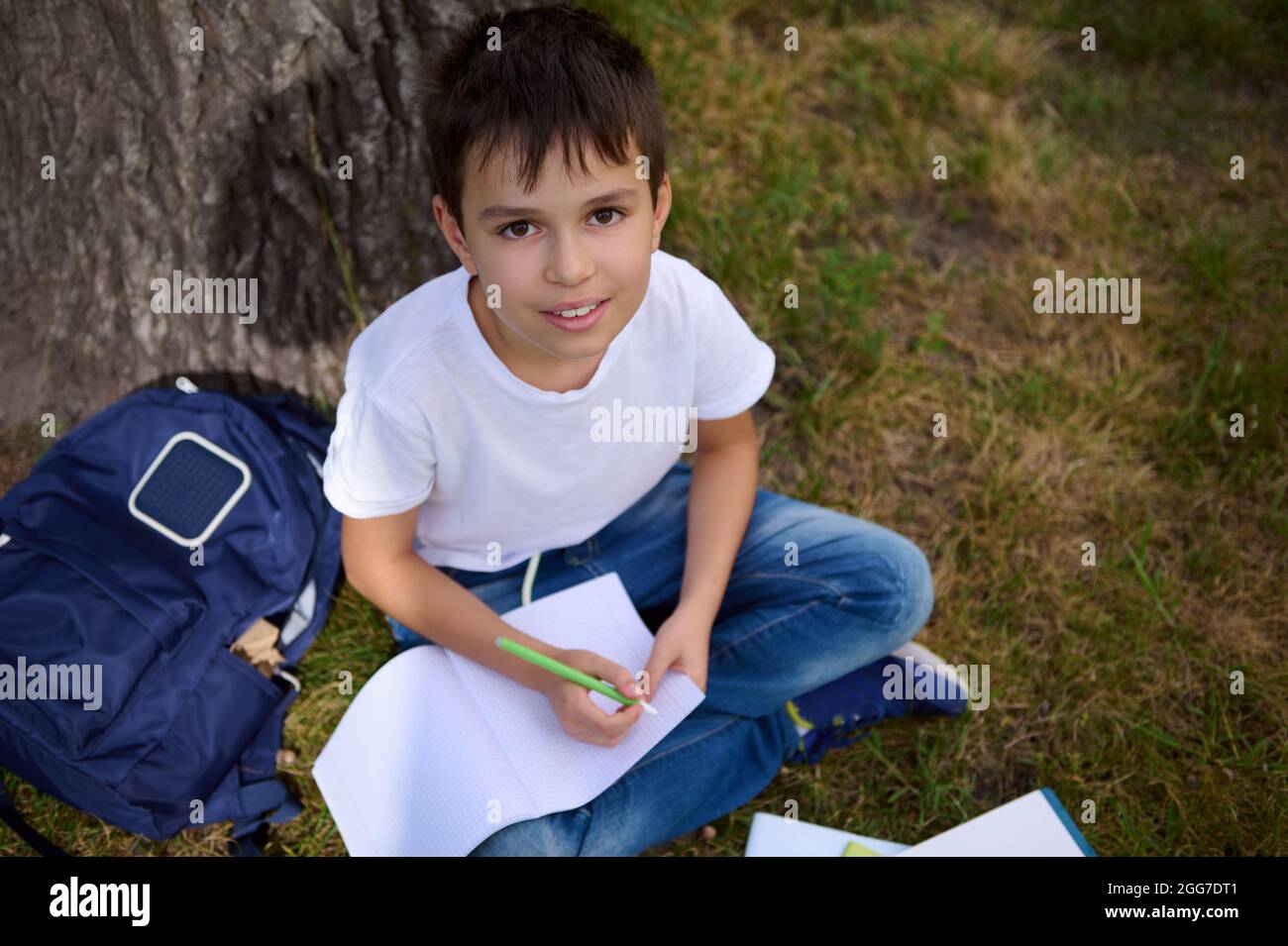 Top view of a cute boy, elementary aged school child, smiling looking ...