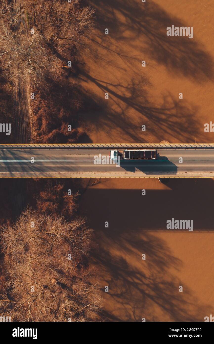 Aerial view of semi-trailer truck crossing the bridge over river ...