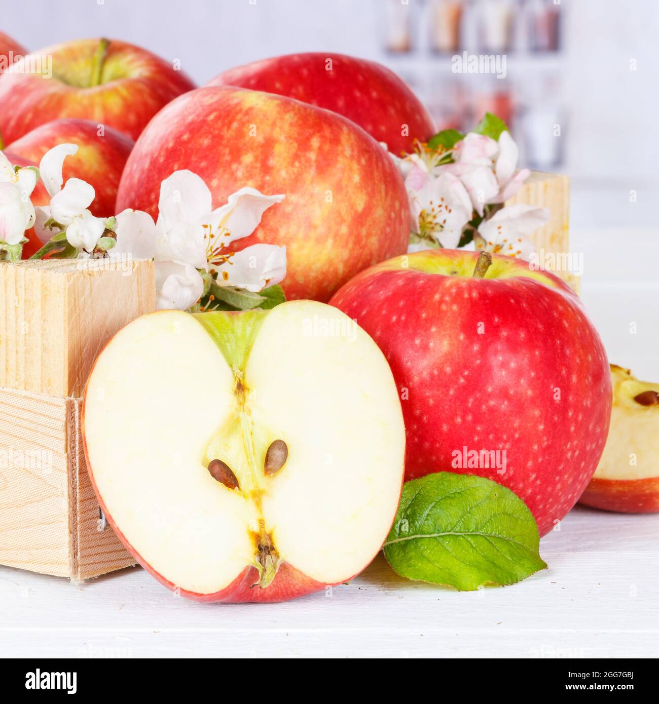 Apples fruits red apple fruit in a box with leaves square and blossoms ...