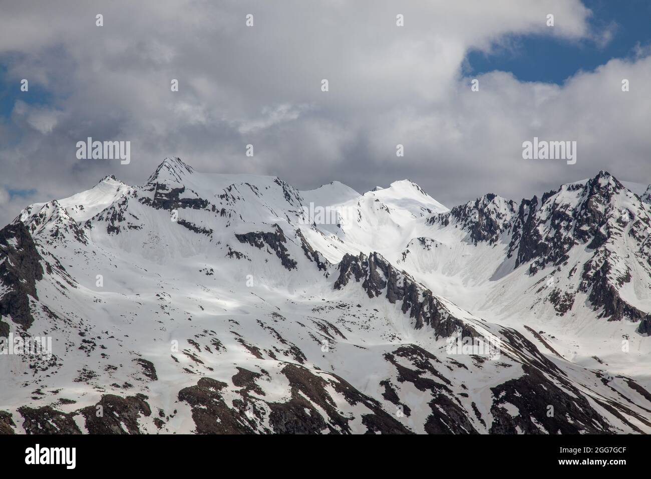 The cloudy sky over the snowy landscapes captured in high in the Alps ...