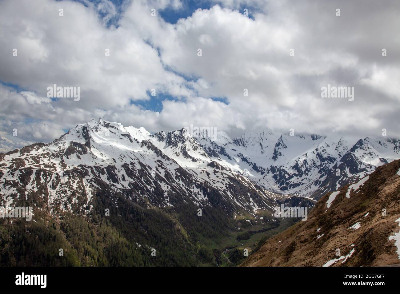 The cloudy sky over the snowy landscapes captured in high in the Alps ...
