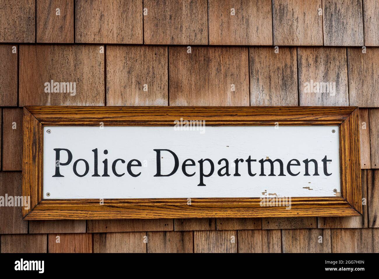white sign with police department text framed in natural wood hanging ...