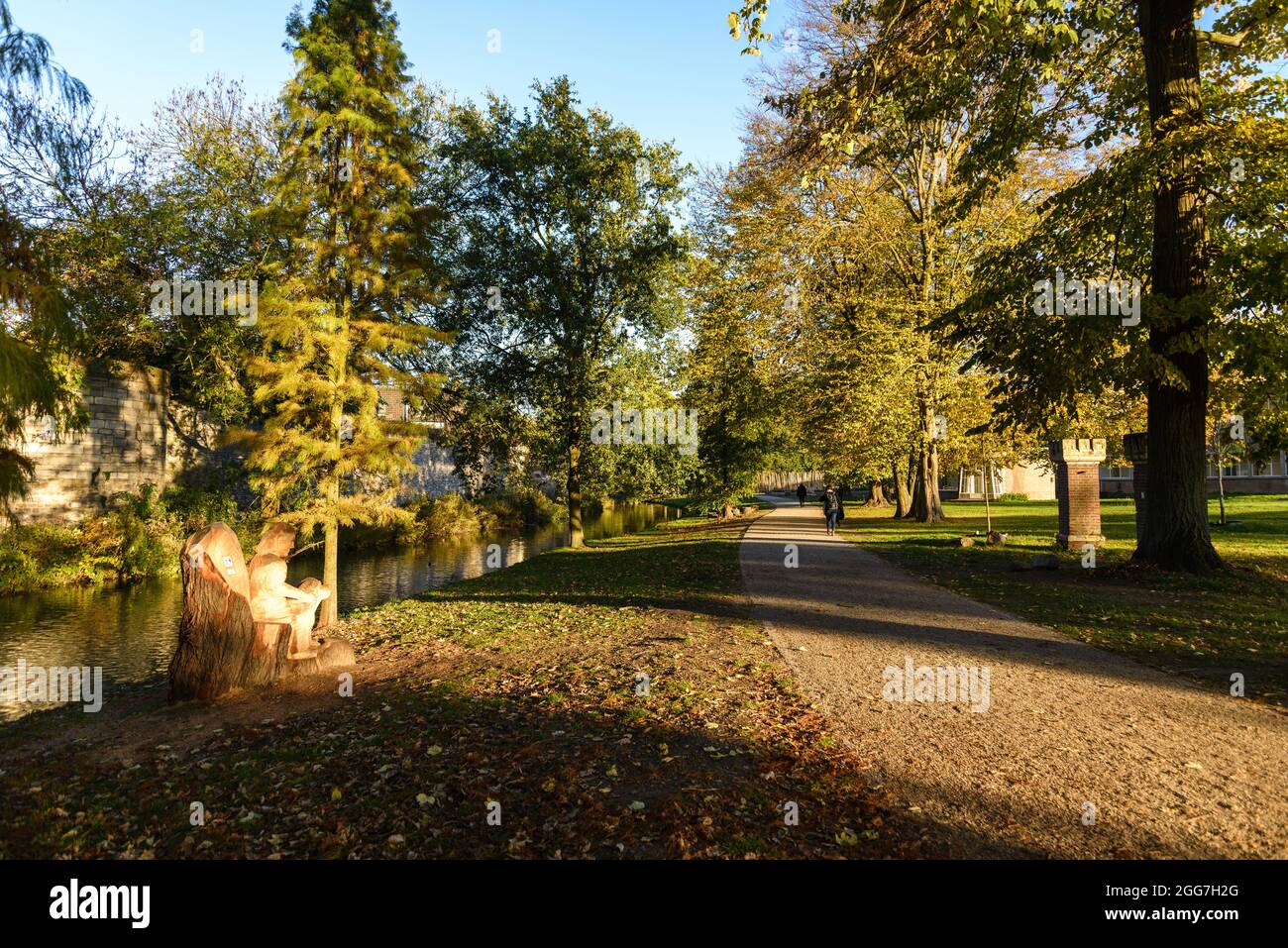 Outdoor scenery of walking way along Jeker canal and historical city ...