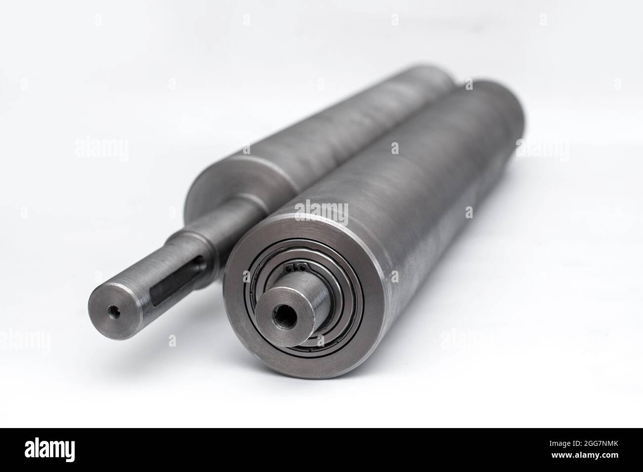 Steel metal pipe-shaft made on a lathe for the factory conveyor ...