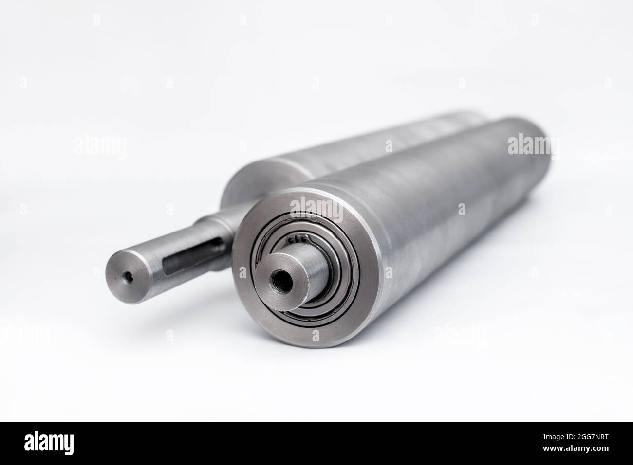 Steel metal pipe-shaft made on a lathe for the factory conveyor ...