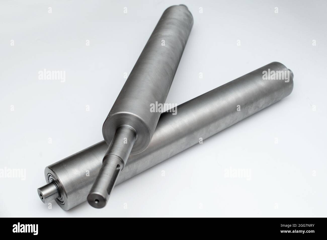 Steel metal pipe-shaft made on a lathe for the factory conveyor ...