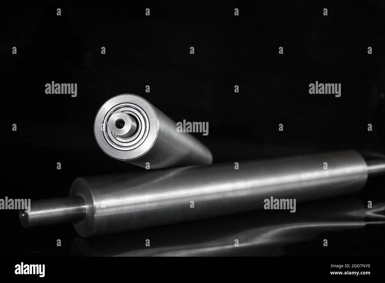 Steel metal pipe-shaft made on a lathe for the factory conveyor ...