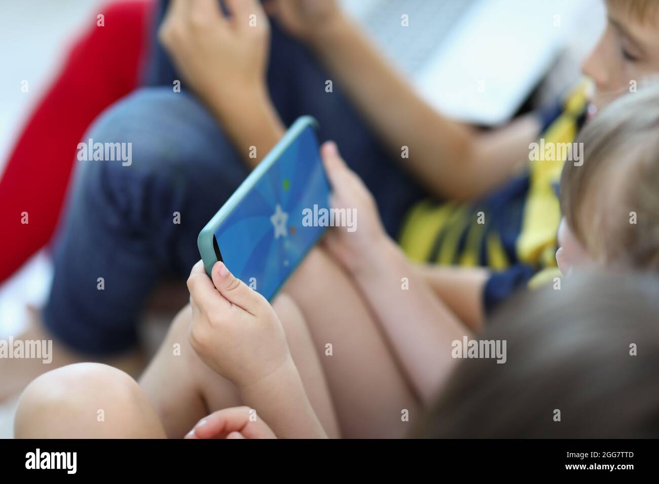 Little children playing game on the phone close-up Stock Photo - Alamy