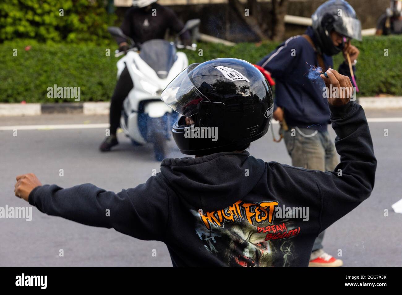 A protester is seen throwing a ping-pong bomb during the demonstration ...