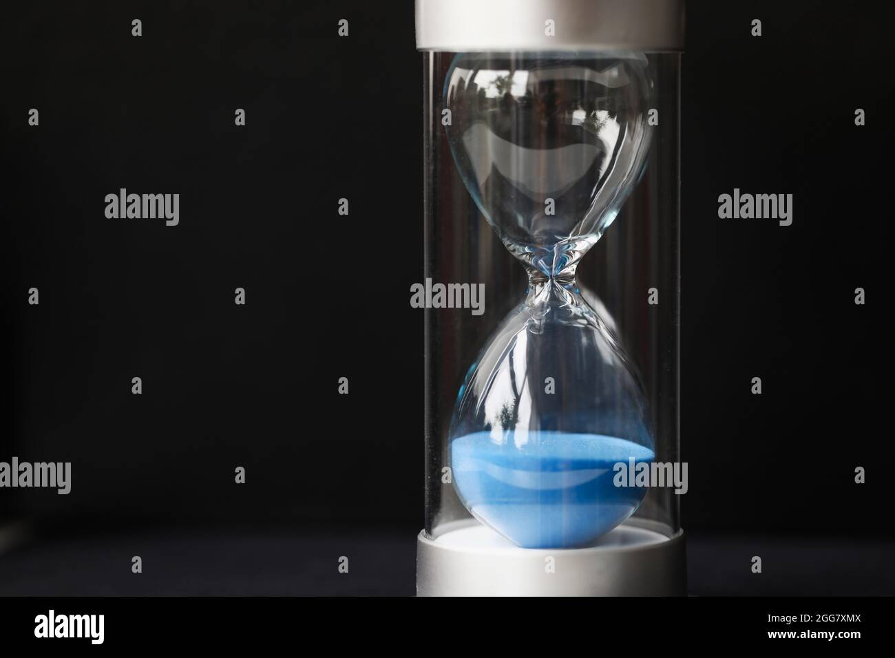 Stylish modern hourglass with blue sand. Vintage mechanism for ...