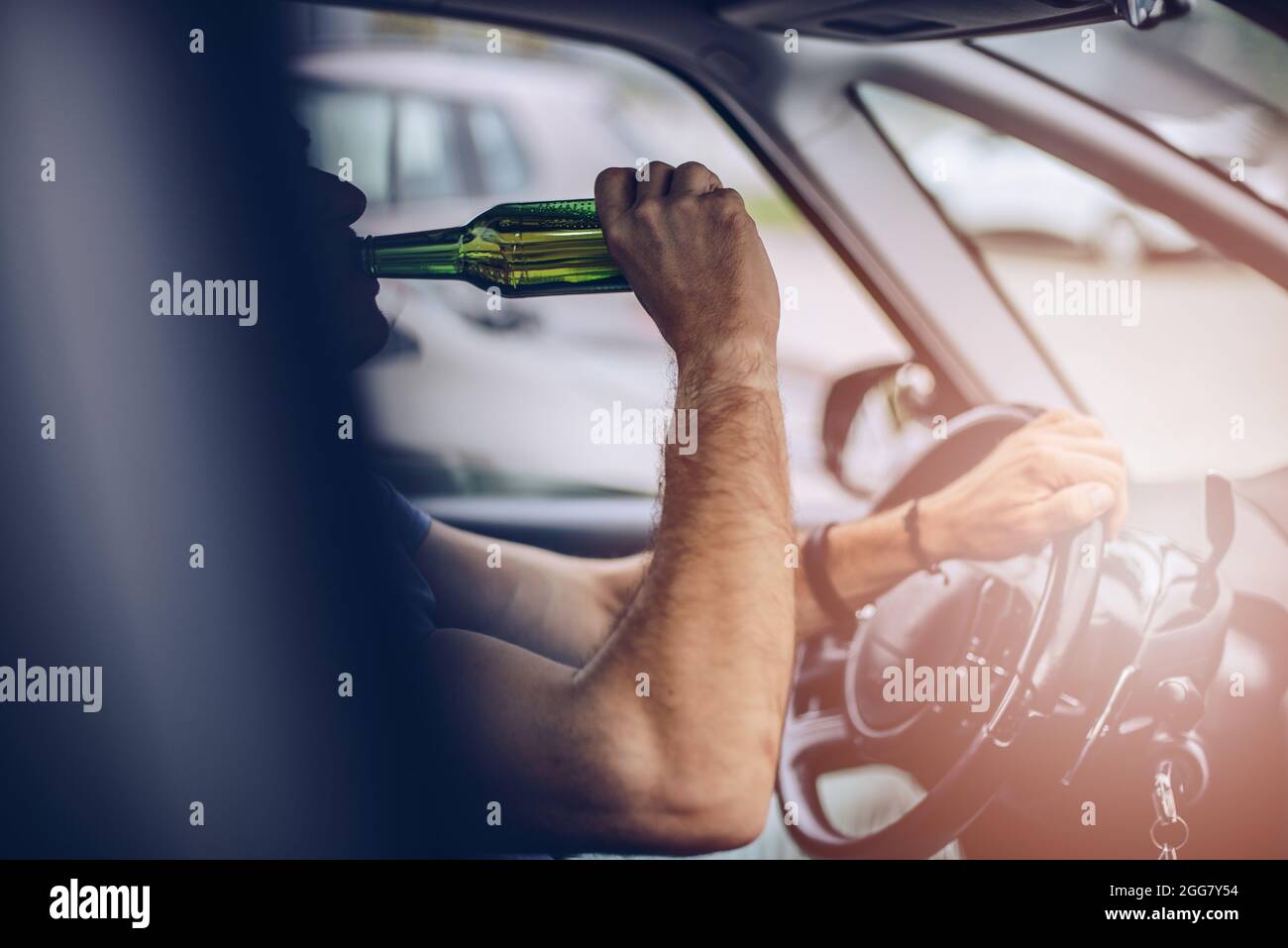 Man drinking beer while driving a car Stock Photo - Alamy