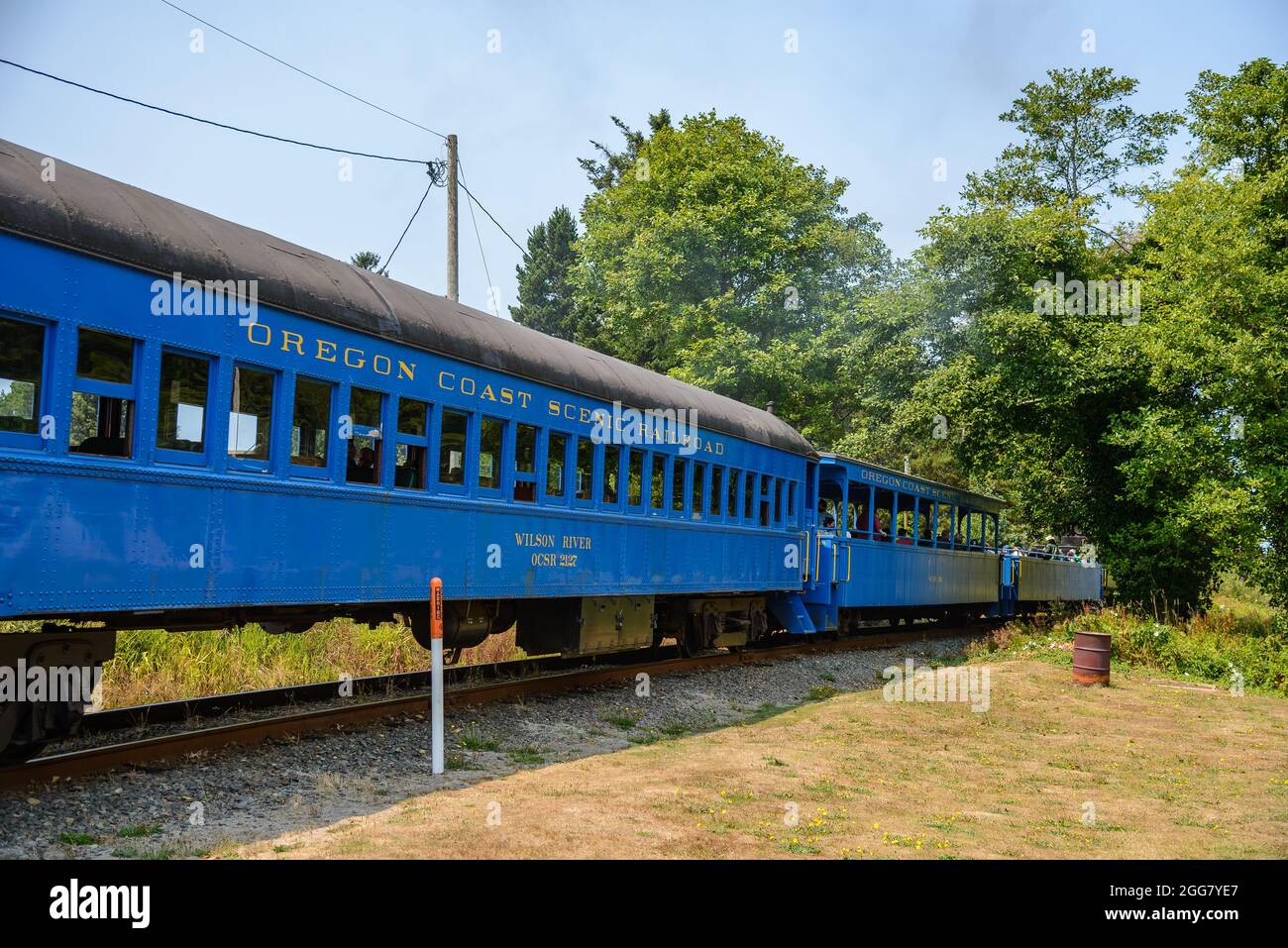 Tourists ride blue train from Oregon Coast Scenic Railroad. Tallimook ...