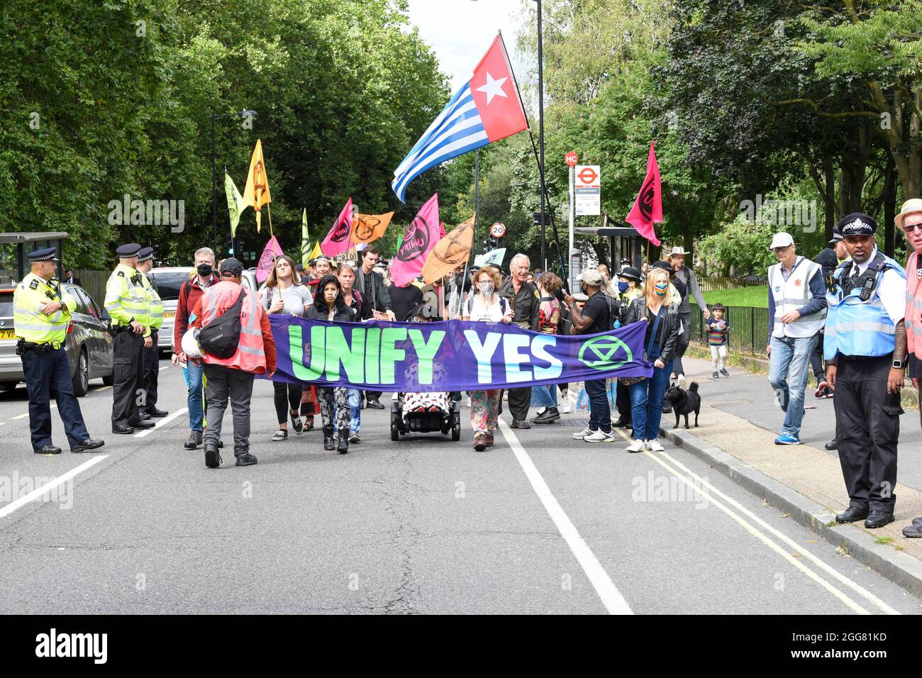 Protesters hold a banner and march to Finsbury Park for a rally at ...