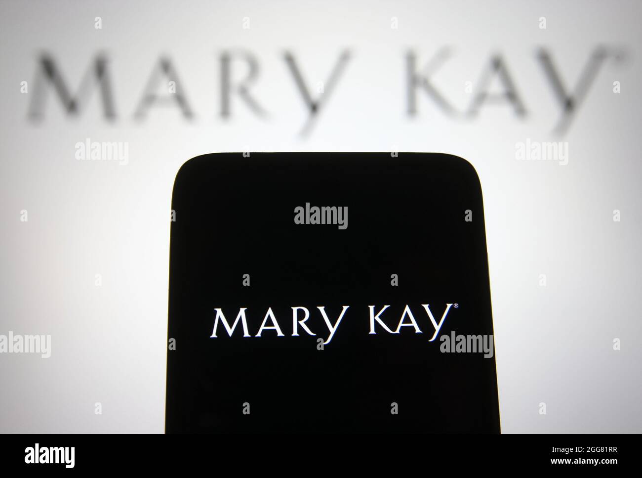 In this photo illustration, Mary Kay logo is seen on a smartphone and a ...