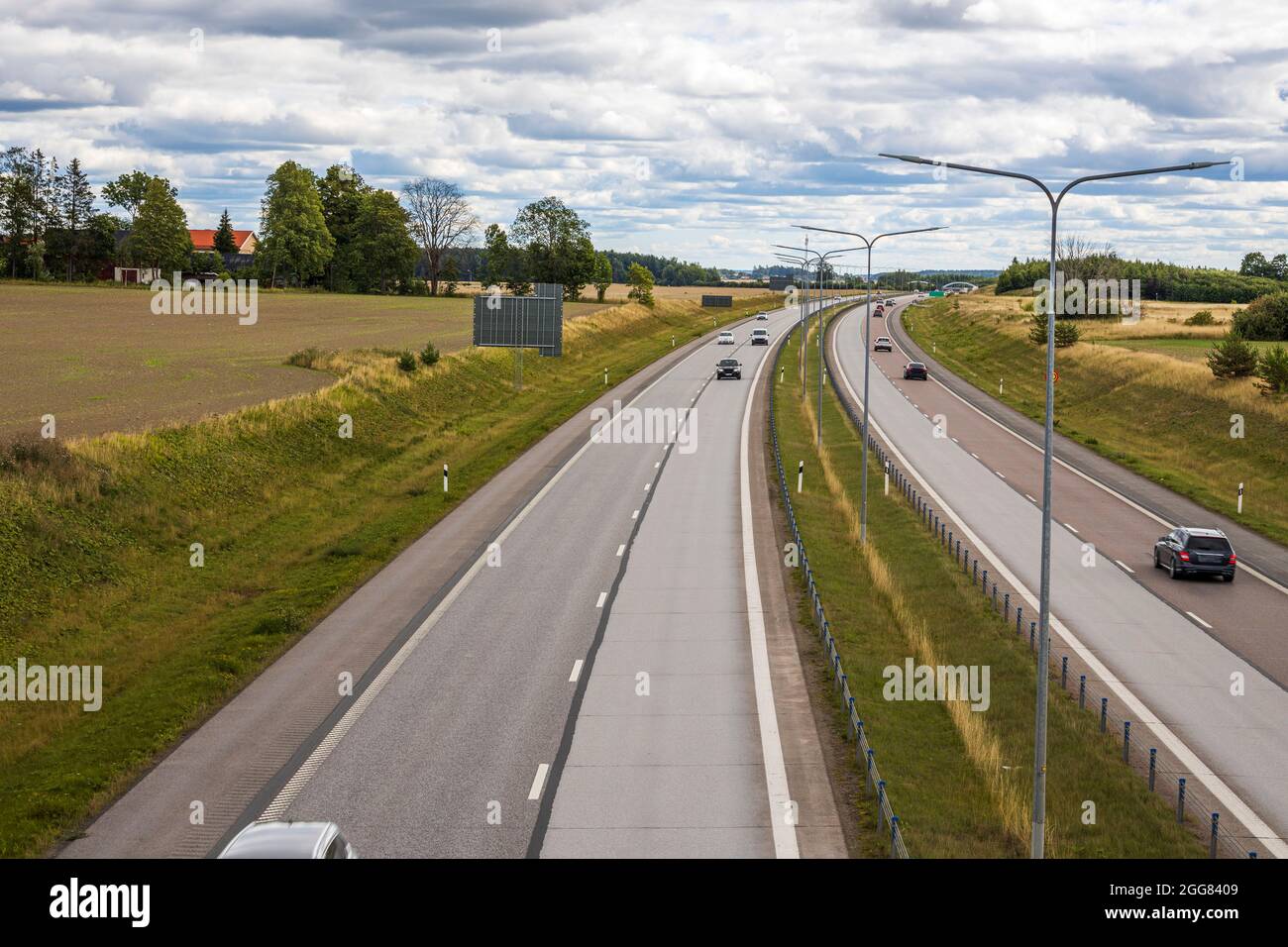 Beautiful view from above on highway road with several cars. Green side ...