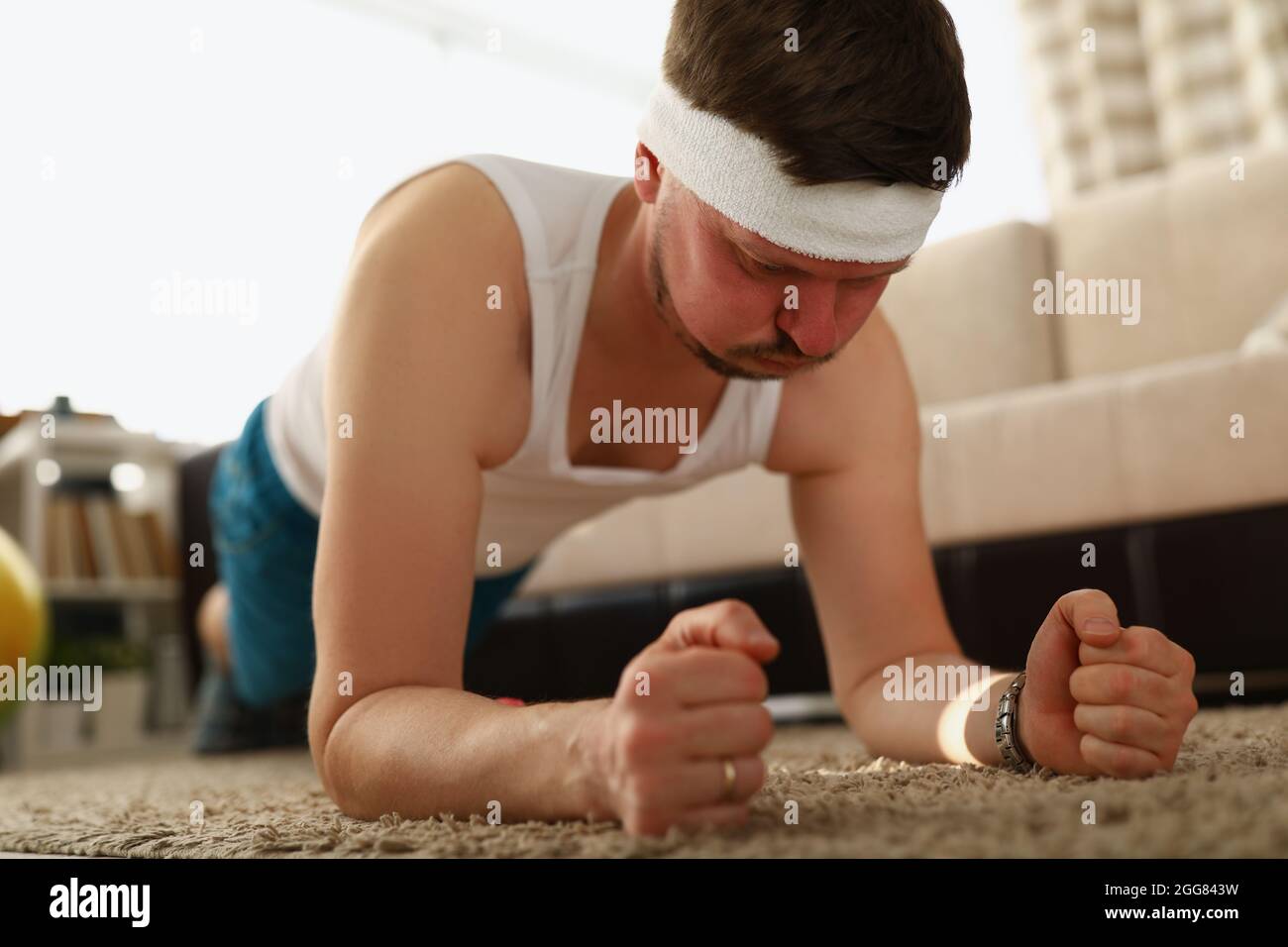 Man performs plank exercises on carpet apartment Stock Photo - Alamy