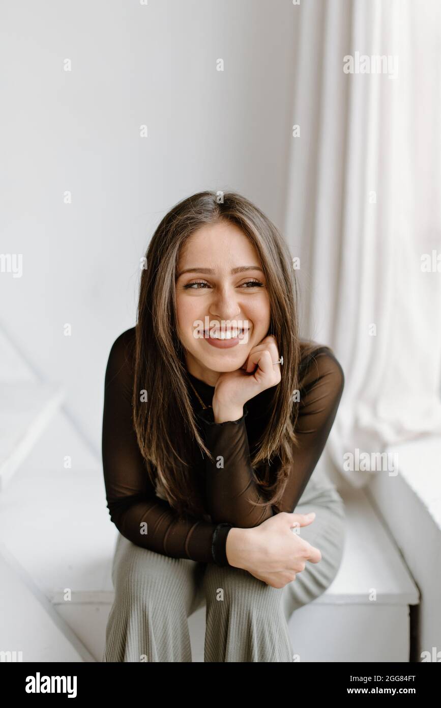 Young woman sitting on stairs hi-res stock photography and images - Alamy