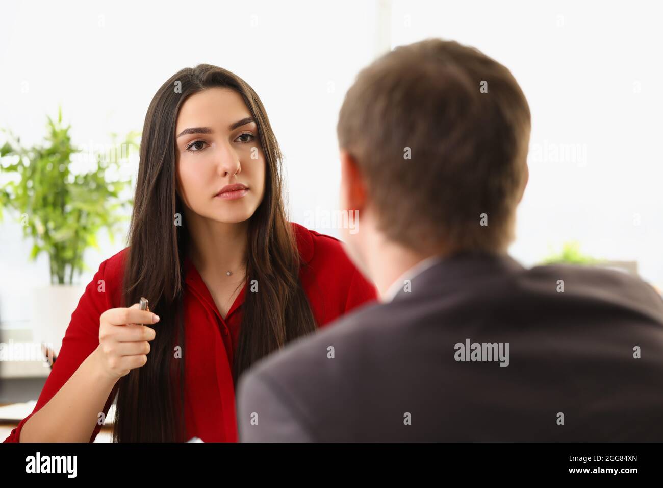 A man in a suit conducts an interview with a woman Stock Photo - Alamy