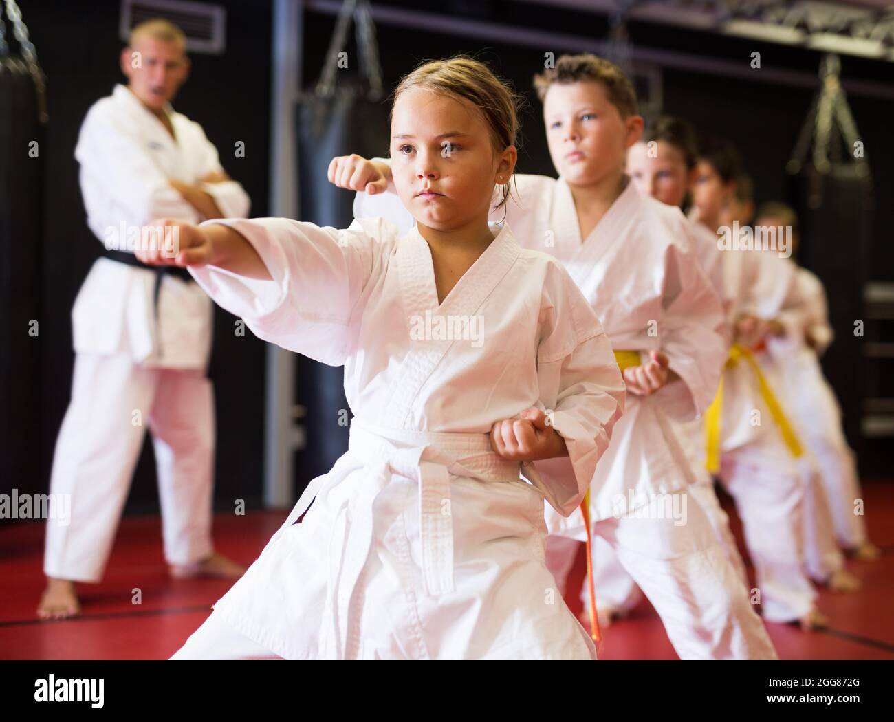Girl practicing new moves during karate class Stock Photo - Alamy