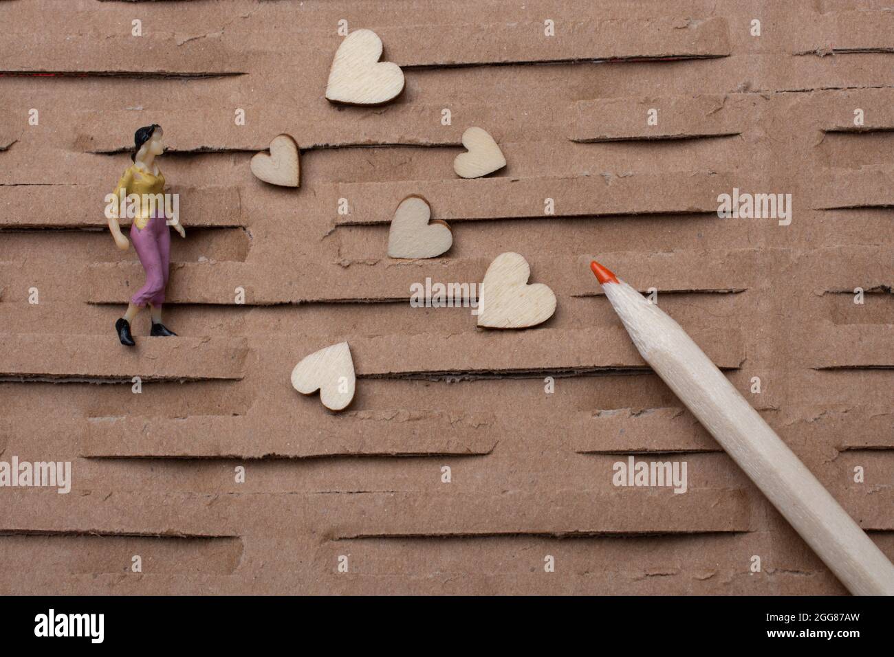 Tiny figurine of woman miniature model and heart as love concept Stock ...