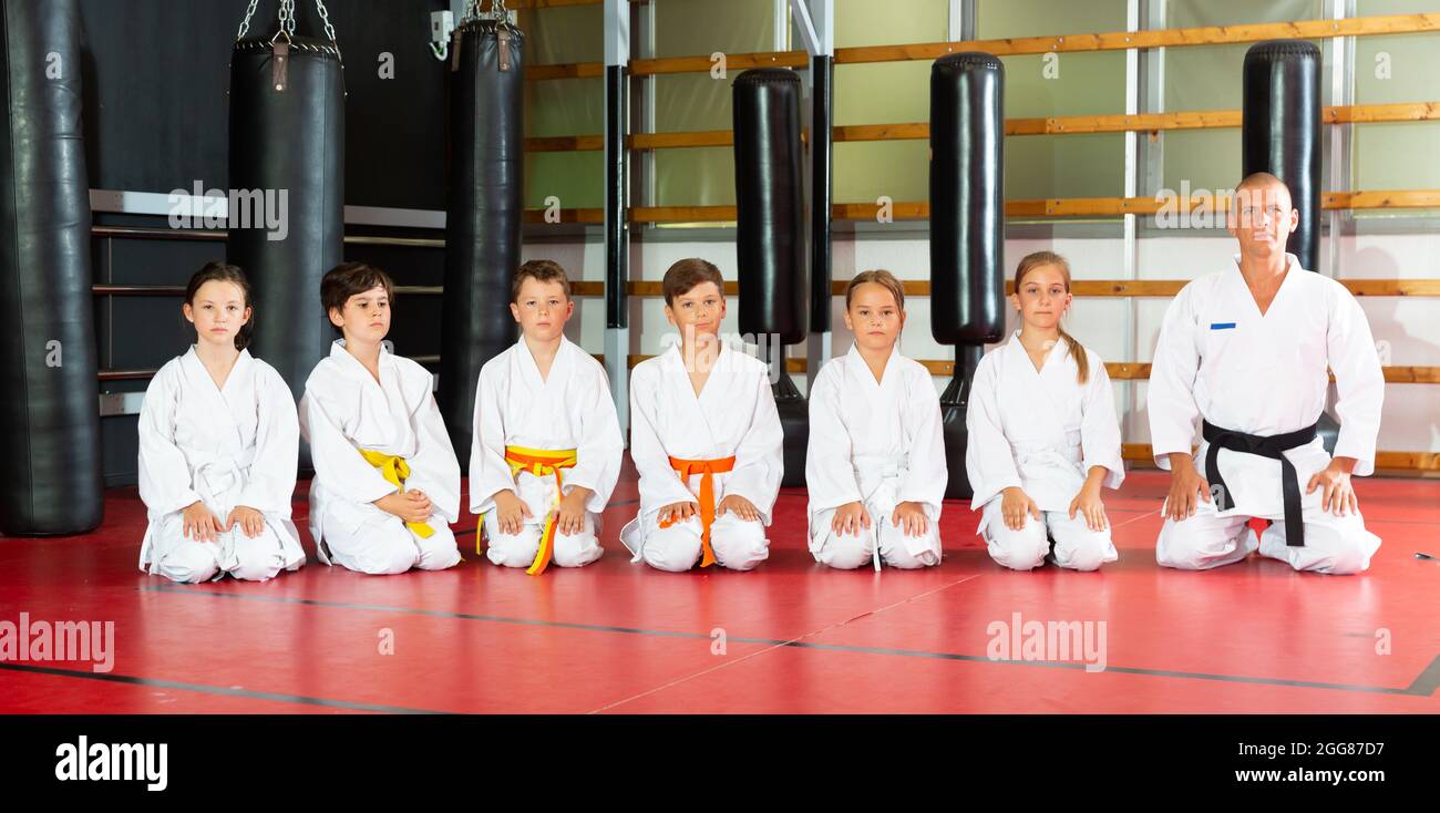 Group of karate kids and their trainer Stock Photo - Alamy