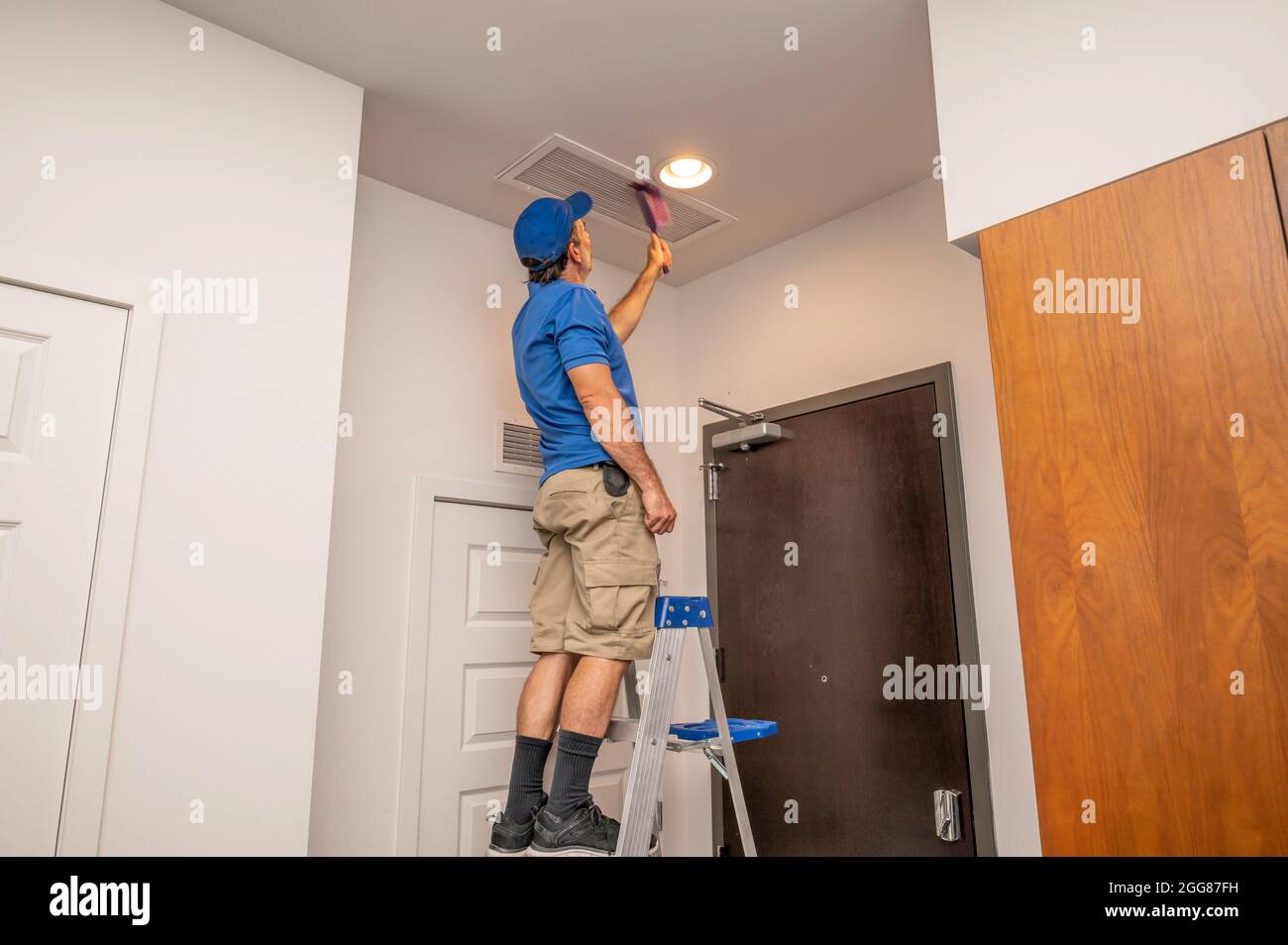 Man on ladder air vent hi-res stock photography and images - Alamy