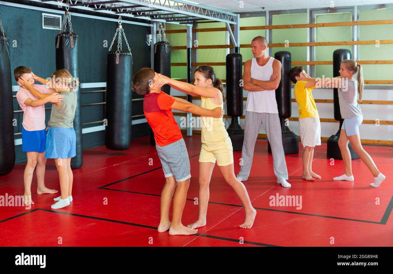 Kids in pair exercising self-defense movements Stock Photo - Alamy