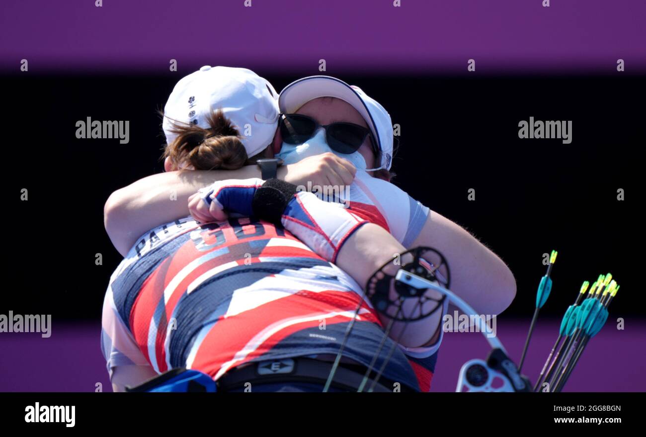 Great Britain's Phoebe Paterson Pine (back to camera) is congratulated ...