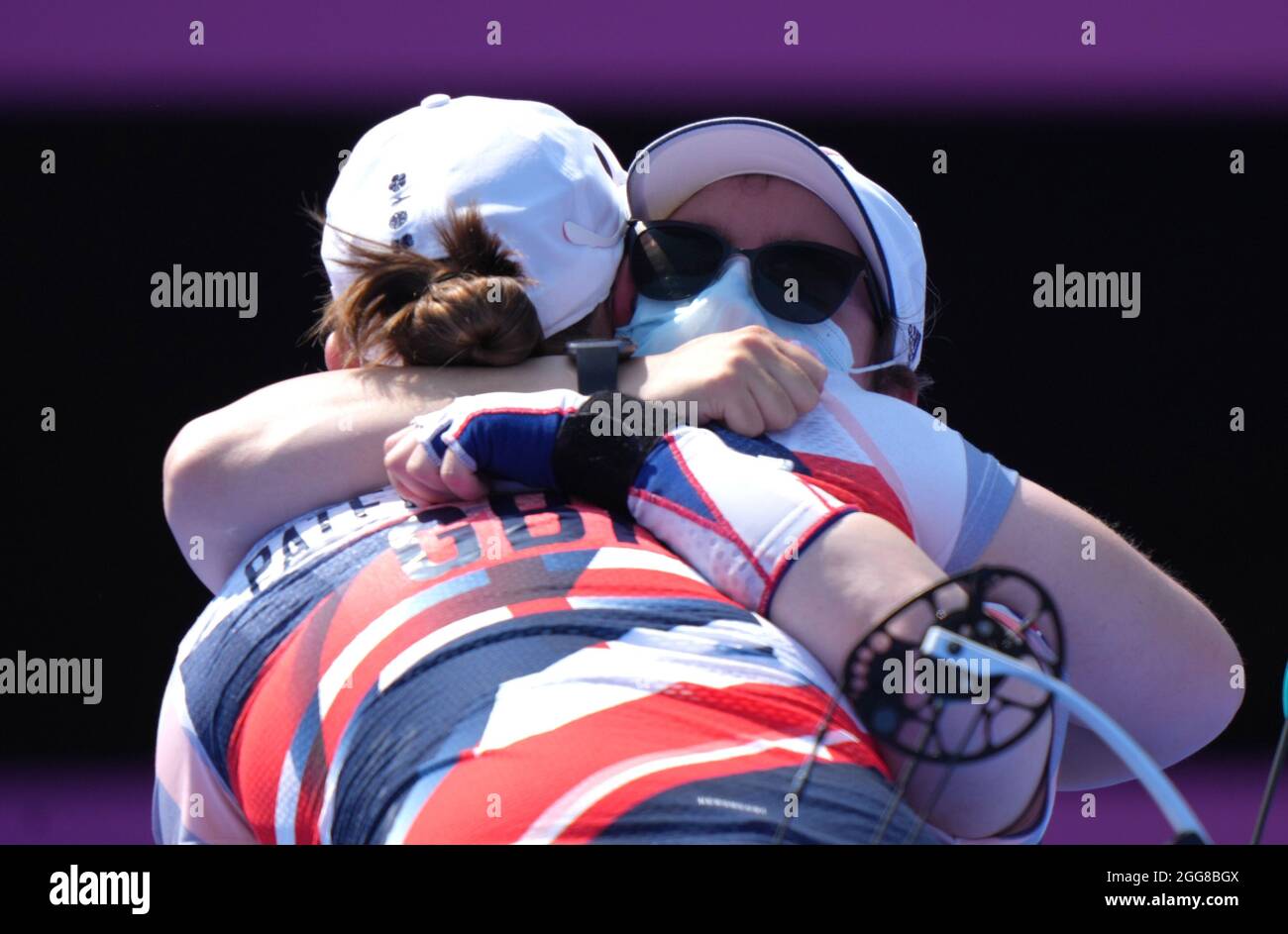 Great Britain's Phoebe Paterson Pine (back to camera) is congratulated ...