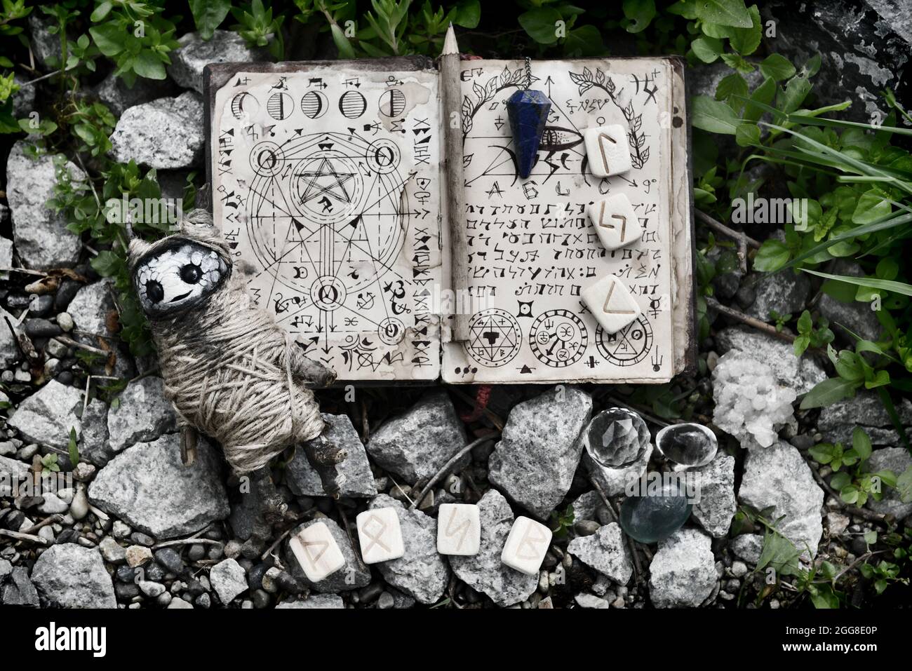 Grunge still life with voodoo doll, runes and witch book of magic ...