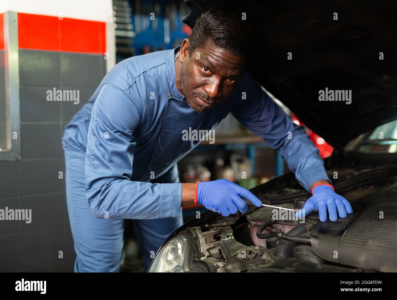 Professional man car mechanician repairing car in auto repair Stock ...