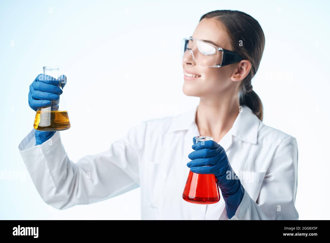 female laboratory assistant chemical solution research science analyzes ...